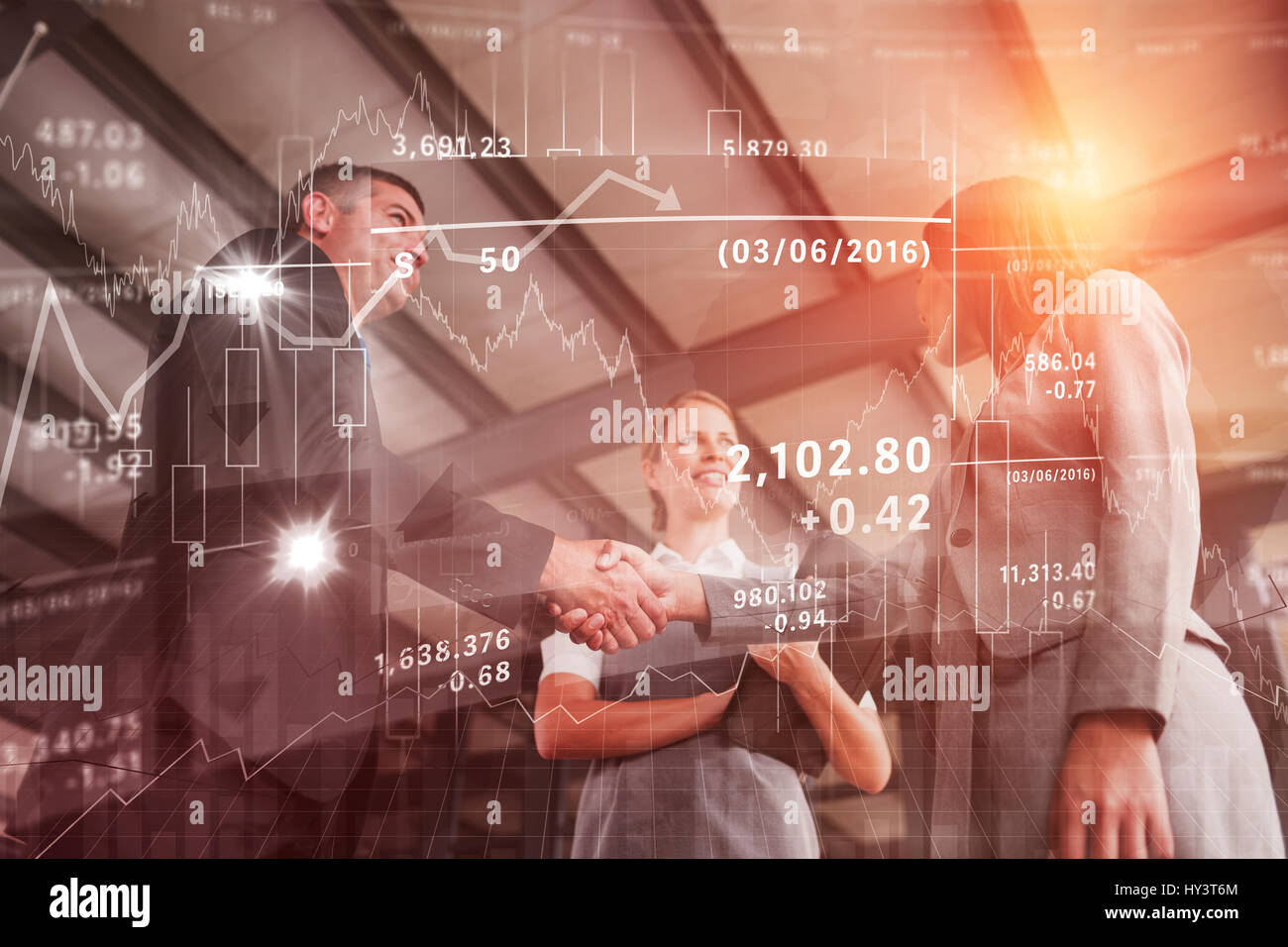 Stocks and shares against business people talking and shaking hands ...