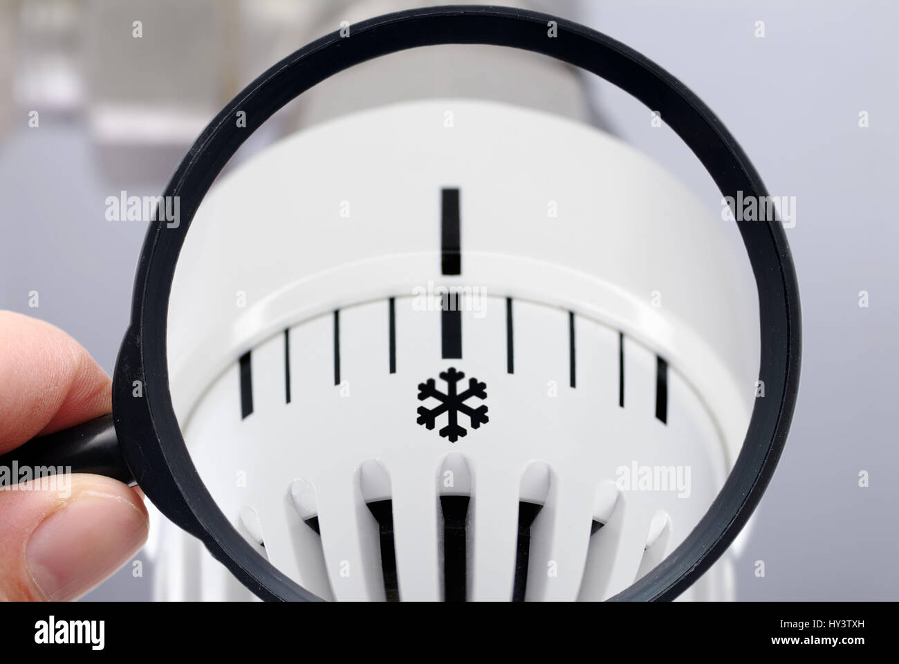 Completed heating thermostat under the magnifying glass, symbolic photo ...