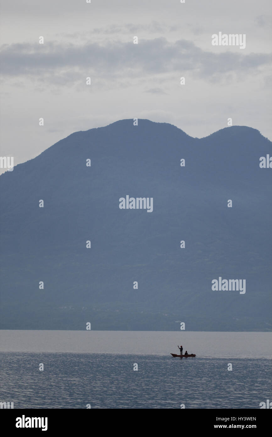 Fishing in an ancient Mayan design boat in Lake Atitlan Stock Photo - Alamy