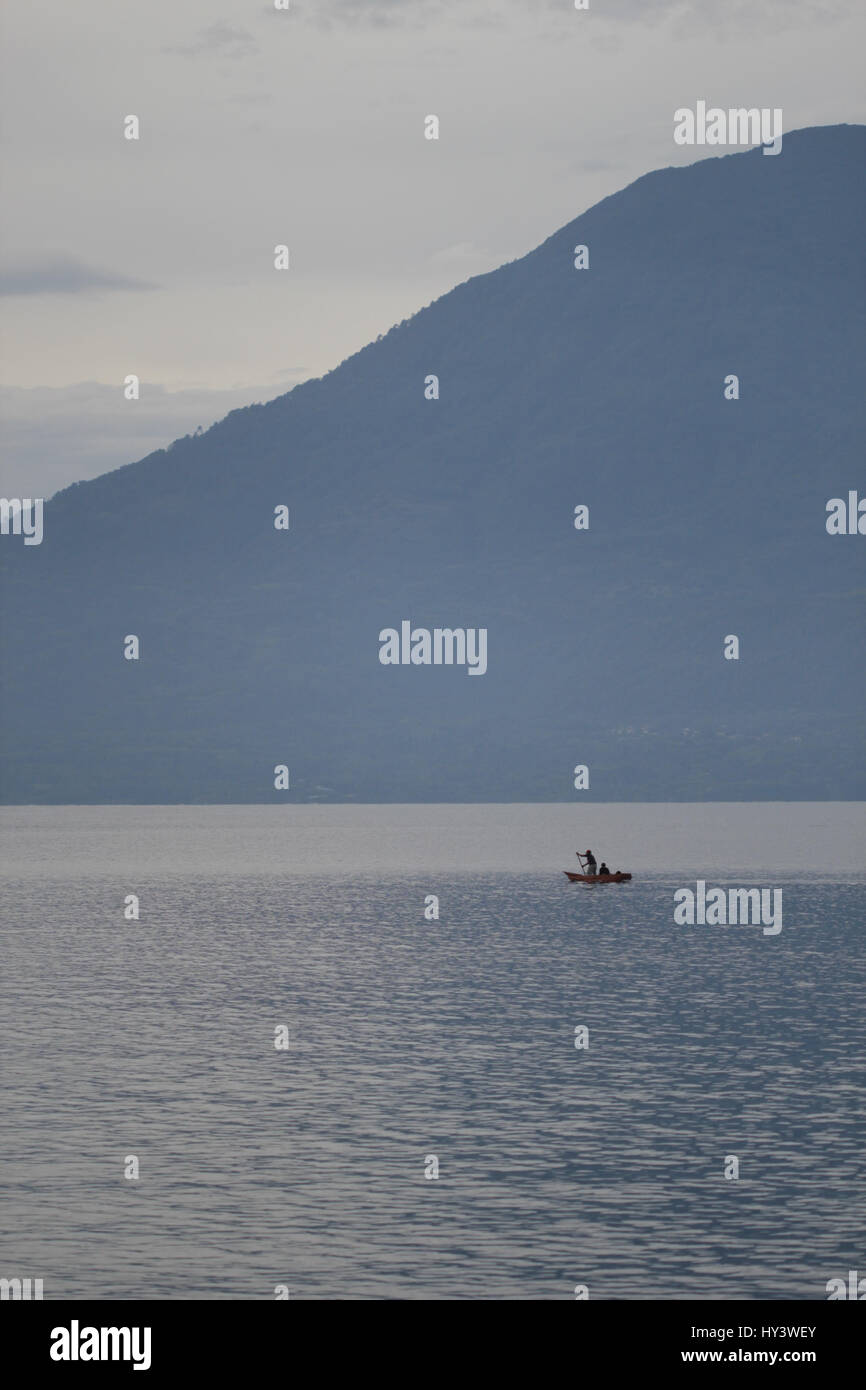 Fishing in an ancient Mayan design boat in Lake Atitlan Stock Photo - Alamy