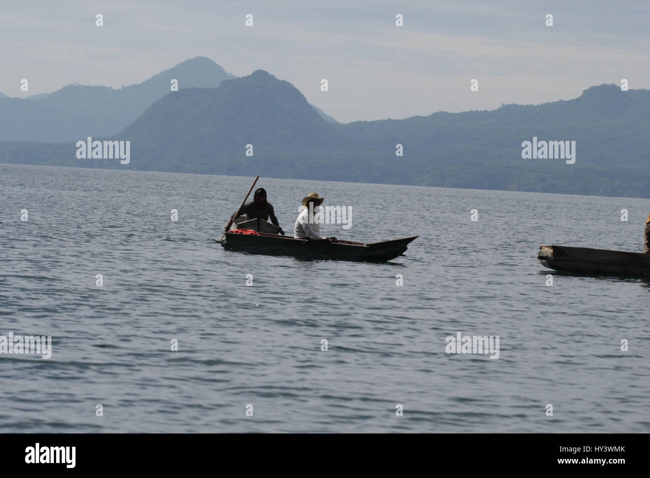 Fishing in an ancient Mayan design boat in Lake Atitlan Stock Photo - Alamy
