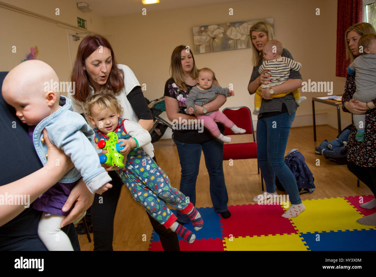 Parents singing songs with children at a playgroup Stock Photo - Alamy