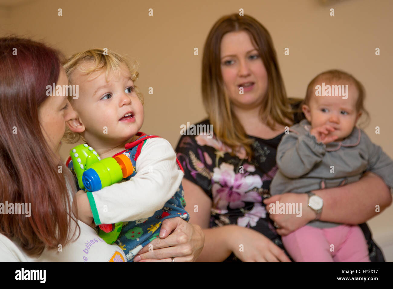 Parents singing songs with children at a playgroup Stock Photo - Alamy