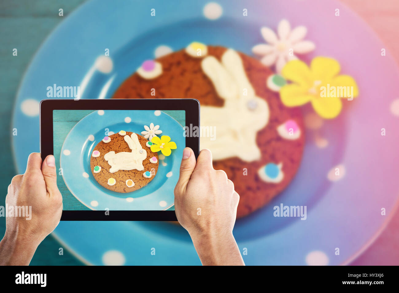 Cropped hand holding digital tablet against cookie with various ...