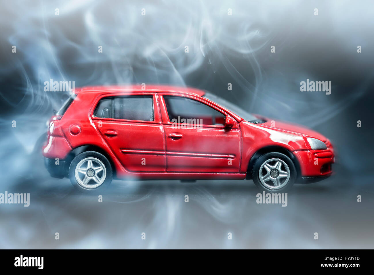 Miniature car and exhaust gases, symbolic photo exhaust gas scandal ...