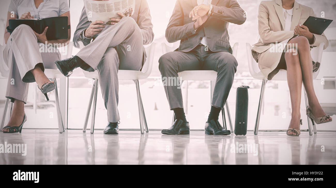 Waiting room with business people sitting in line at corridor Stock ...