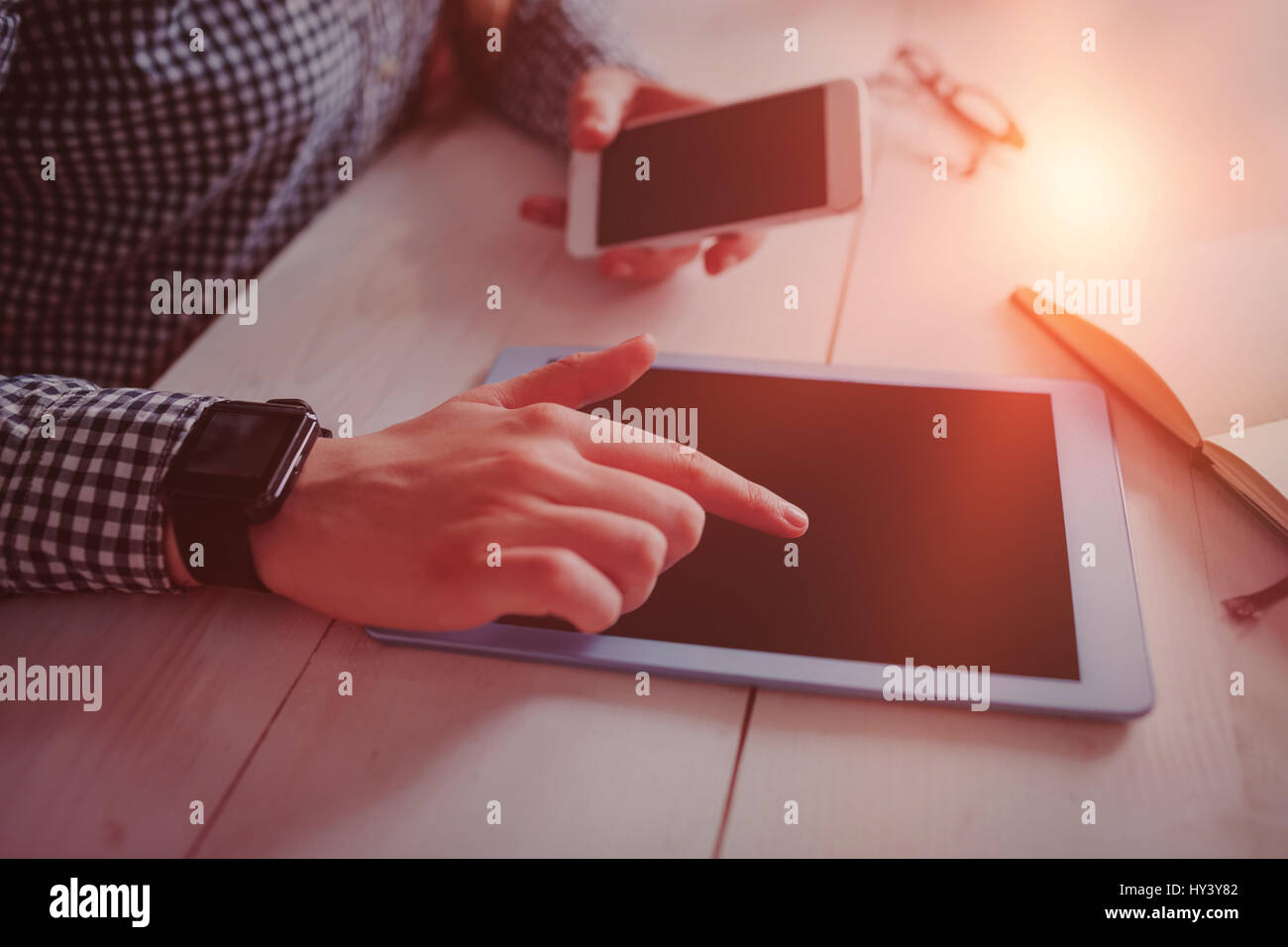 Hand using tablet and smartphone Stock Photo - Alamy