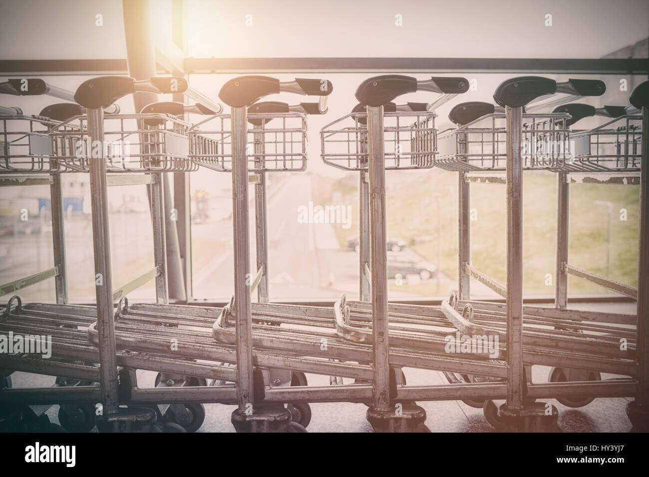 Shopping carts against window at supermarket Stock Photo - Alamy