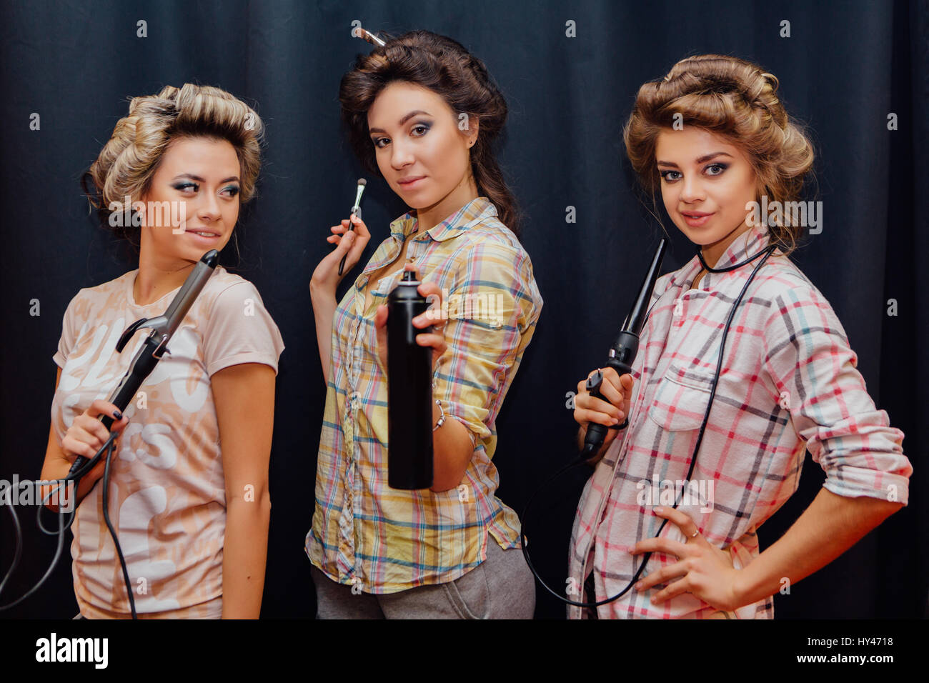 Portrait of three young girls making hairdress to each other Stock ...