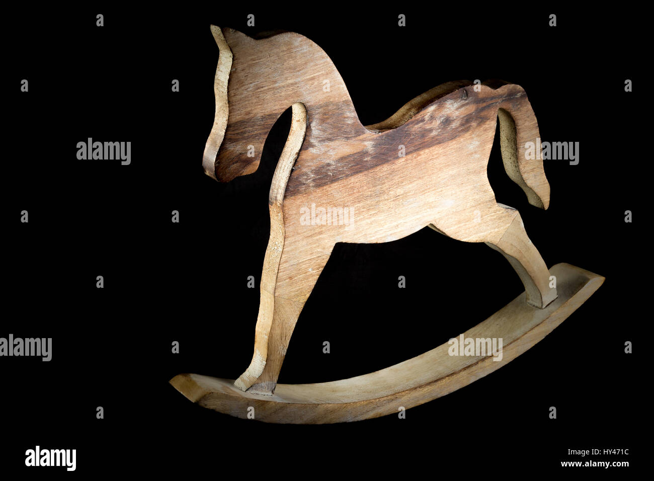 Rocking Horse carved on natural wood isolated on black background Stock ...