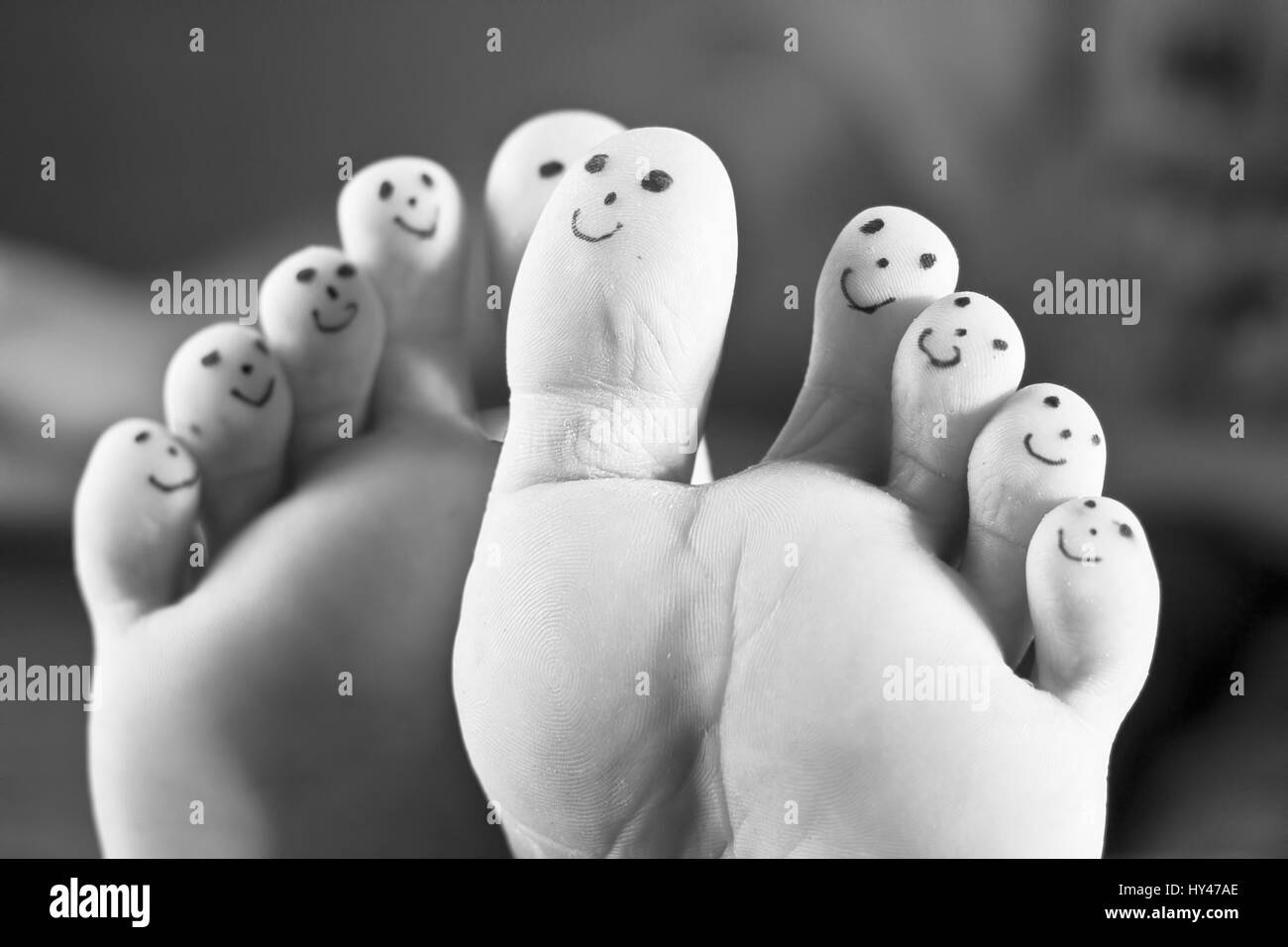all ten toes of feet with smiley faces drawn with black pen Stock Photo ...