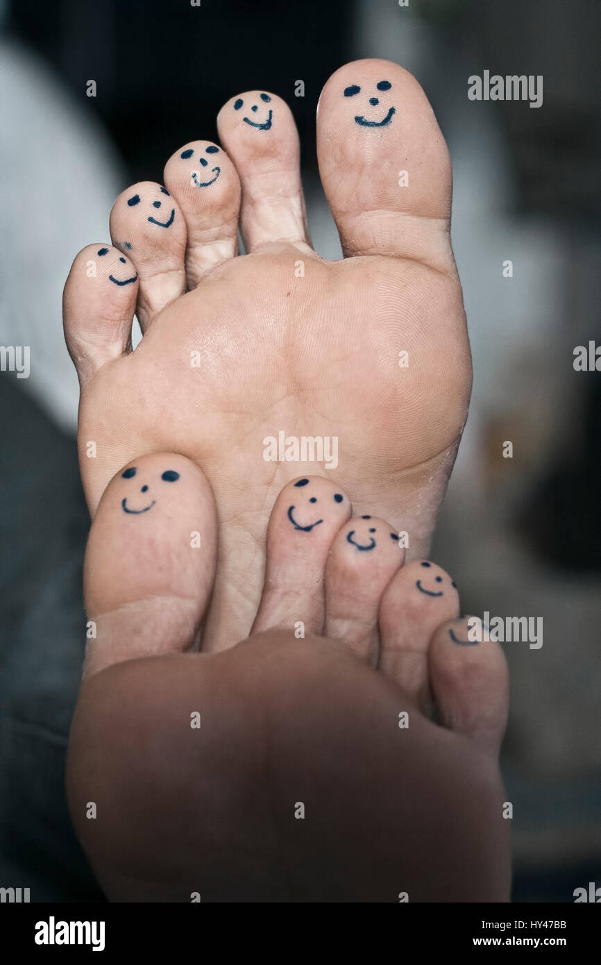 all ten toes of feet with smiley faces drawn with black pen Stock Photo ...