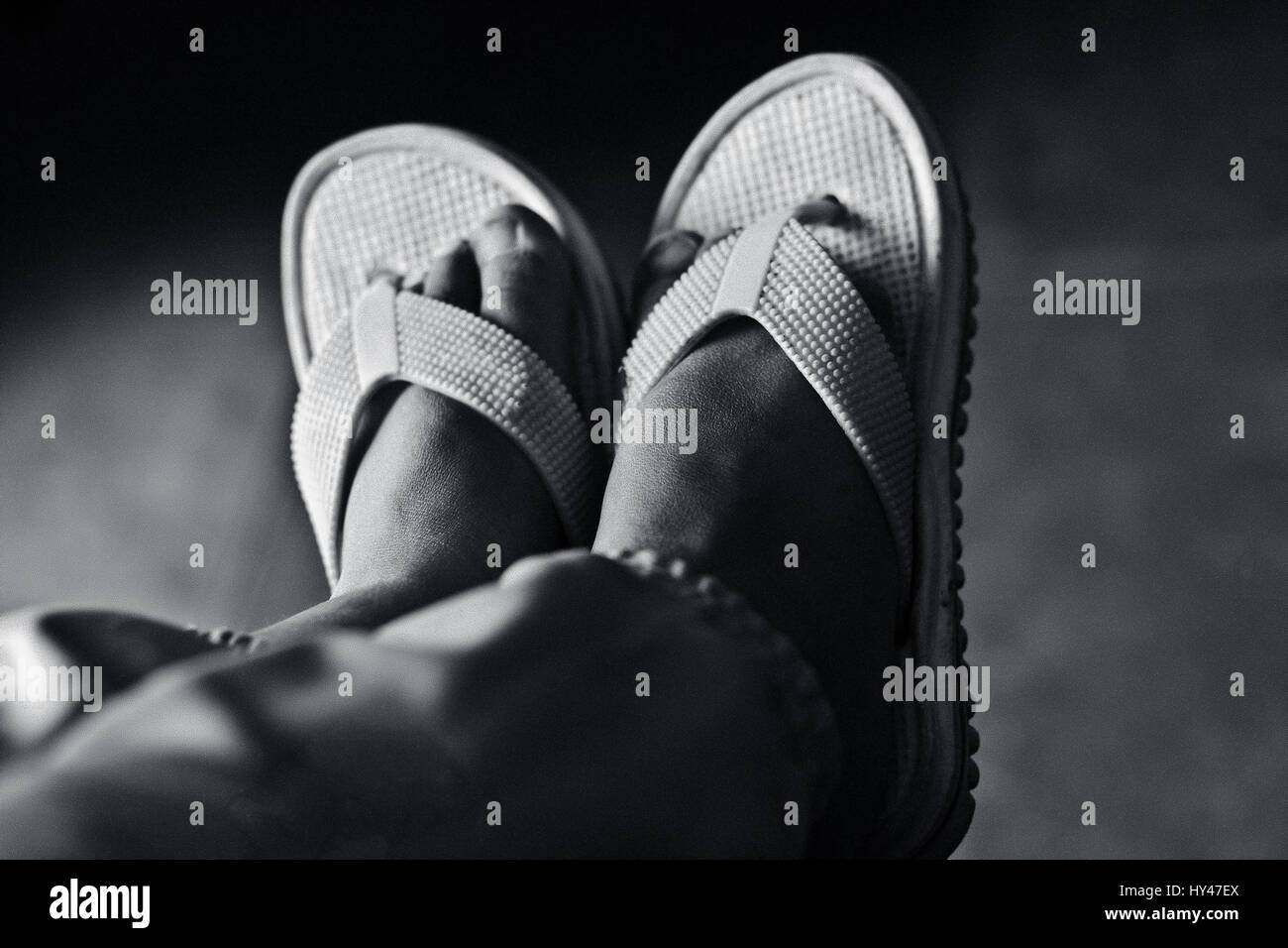 kid wearing sleeper shoes in the worng feet Stock Photo - Alamy