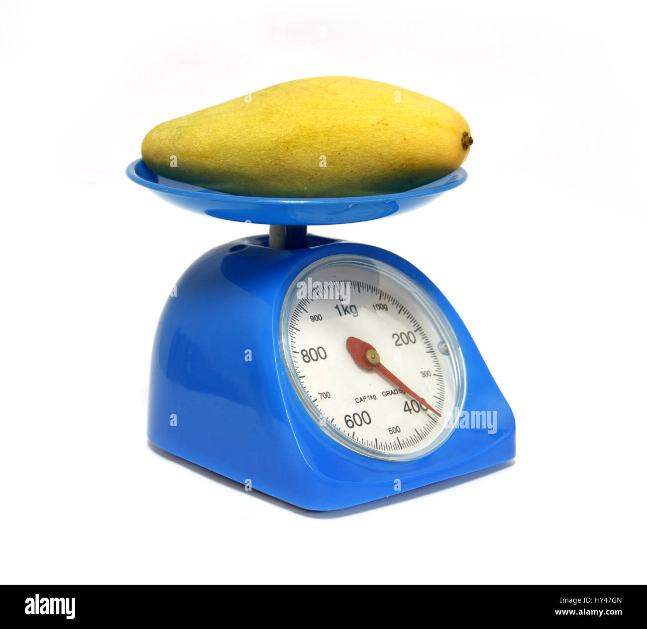 blue color Scales and yellow mangoes on white background Stock Photo ...