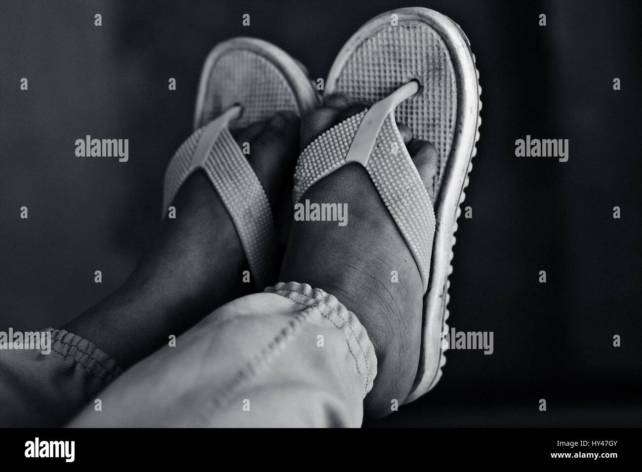 kid wearing sleeper shoes in the worng feet Stock Photo - Alamy