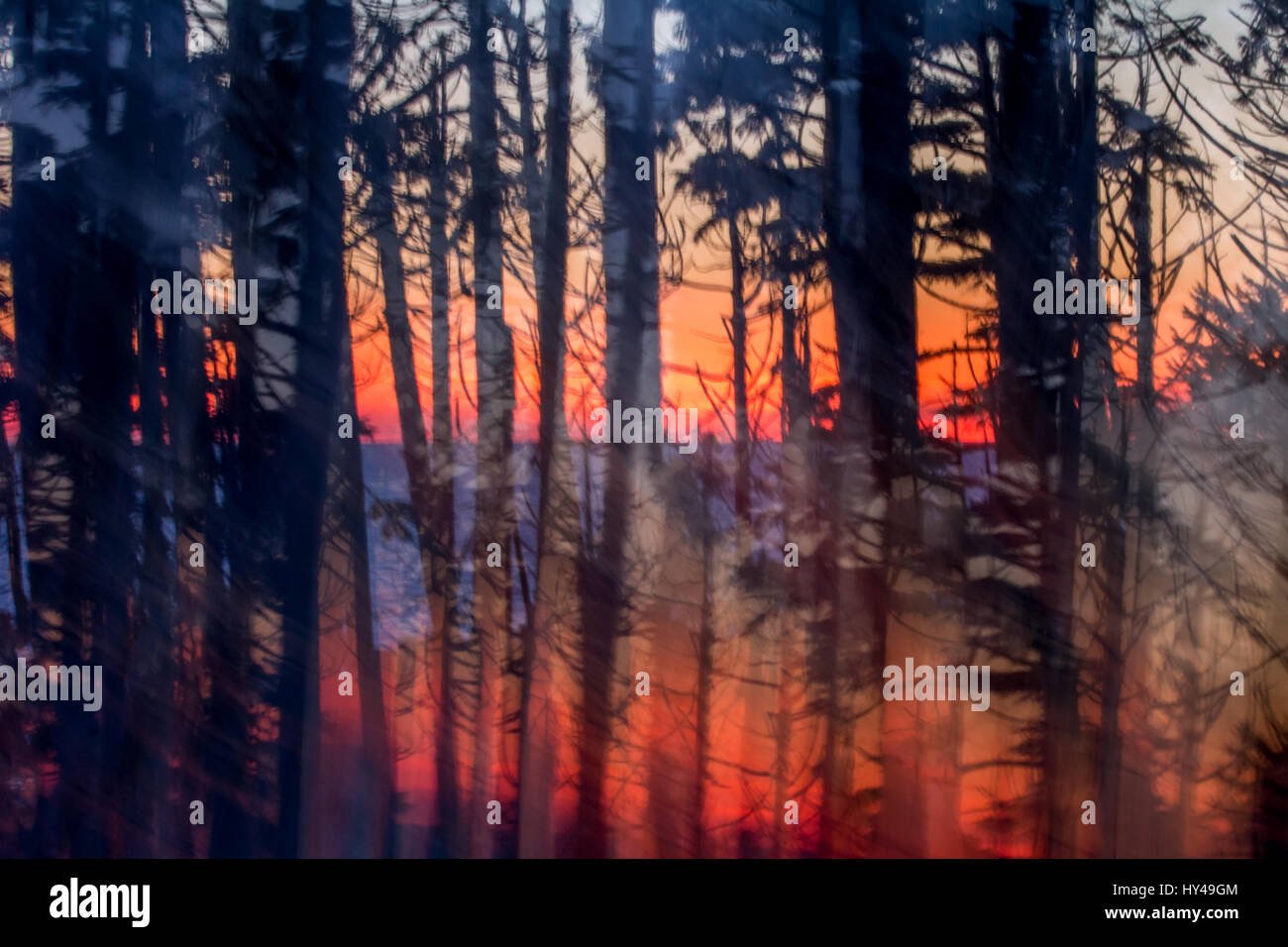 Glorious orange and red sky after sunset over the ocean gives brightly ...