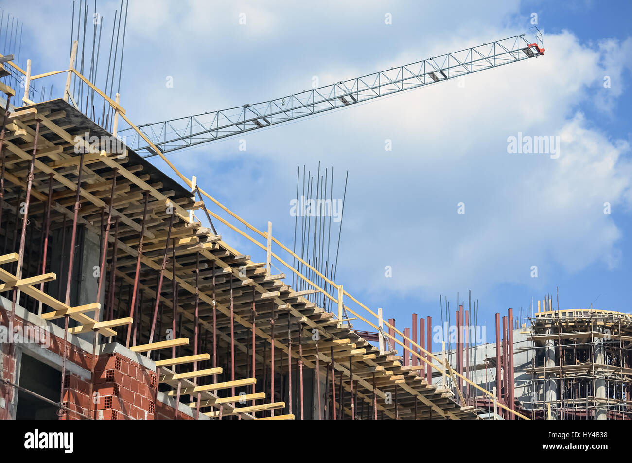 Detail of a reinforced building under construction and a crane Stock ...