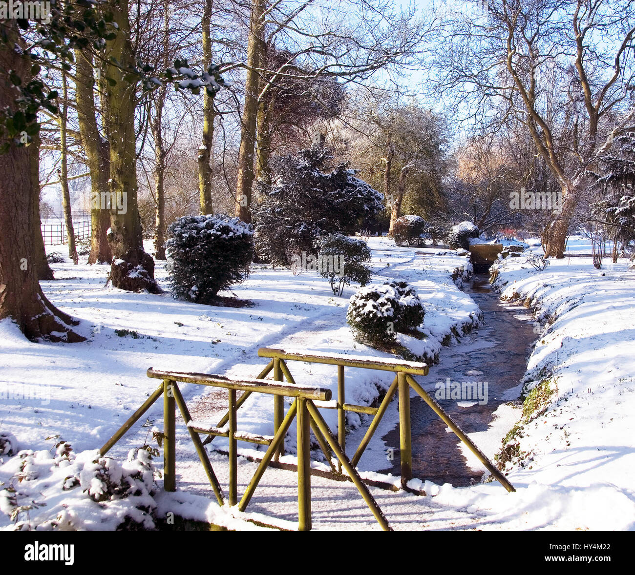 Rustic bridge in Little Ponton Hall gardens with a carpet of snow Stock ...