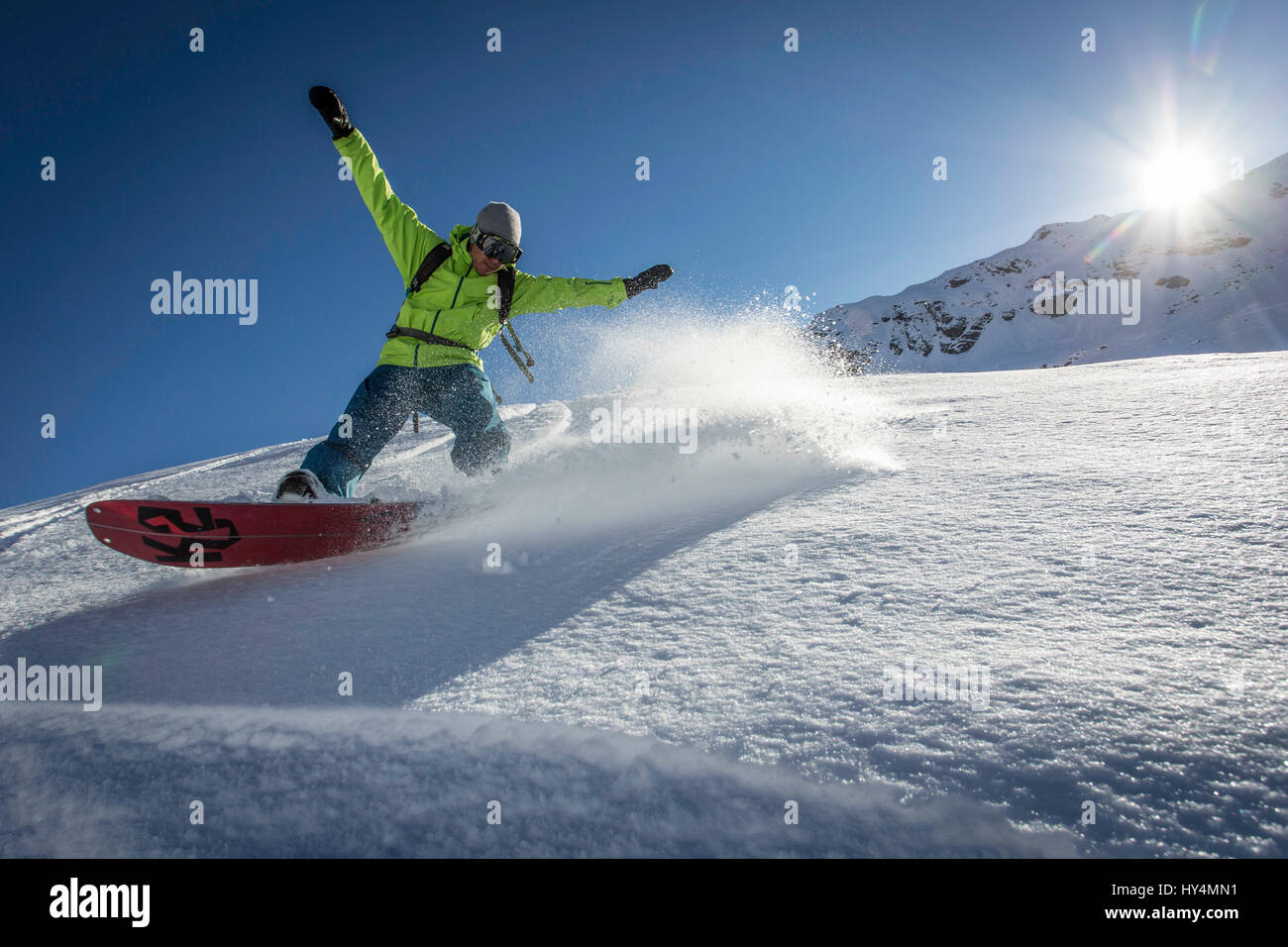 Snowboarder, Powder turn against the light Stock Photo - Alamy