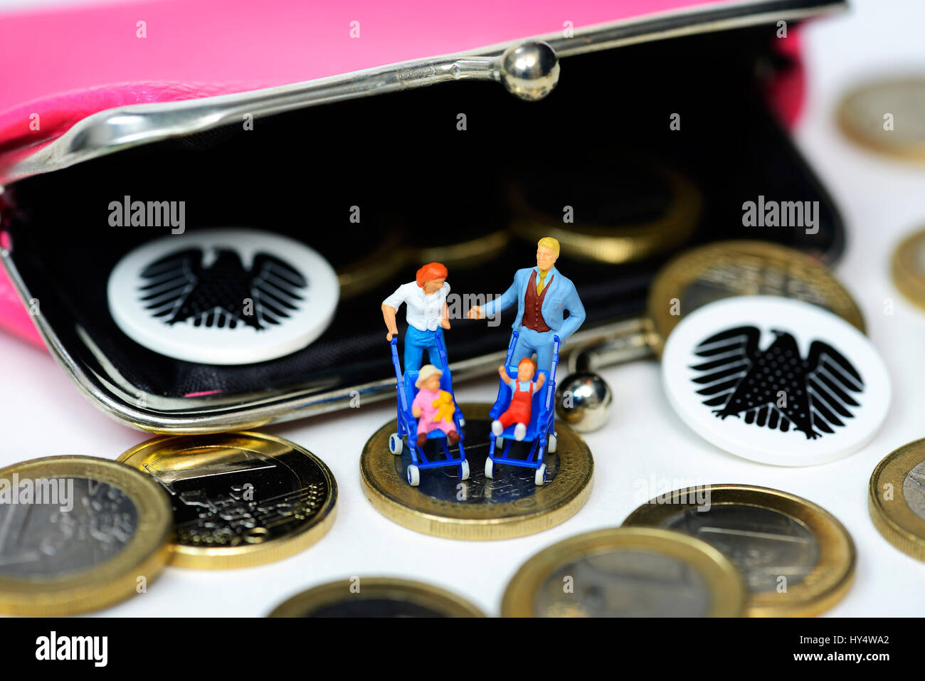 Miniature figures of a family before a change purse, symbolic photo ...