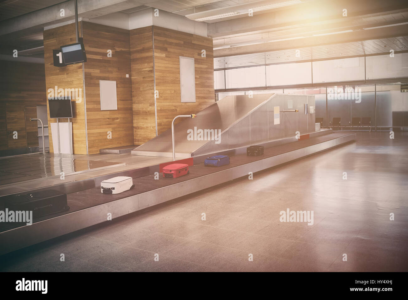 Suitcase on baggage claim at airport Stock Photo - Alamy