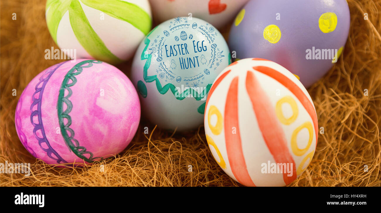 Easter egg hunt logo against painted easter eggs in nest Stock Photo ...