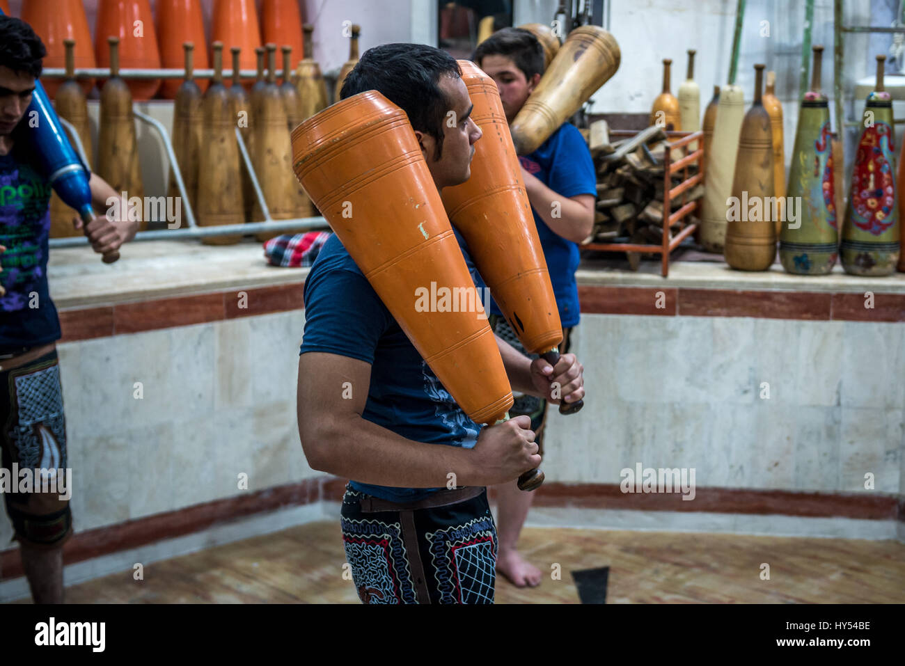 Iranian men and boys training with wooden clubs in Zoorkhaneh (House of ...