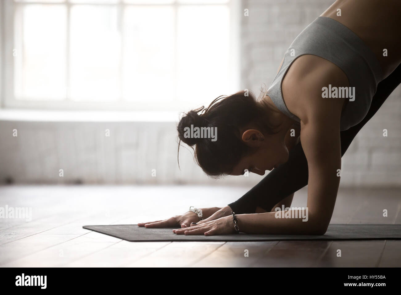 Young woman in One Sided Fold pose, white studio, closeup Stock Photo ...