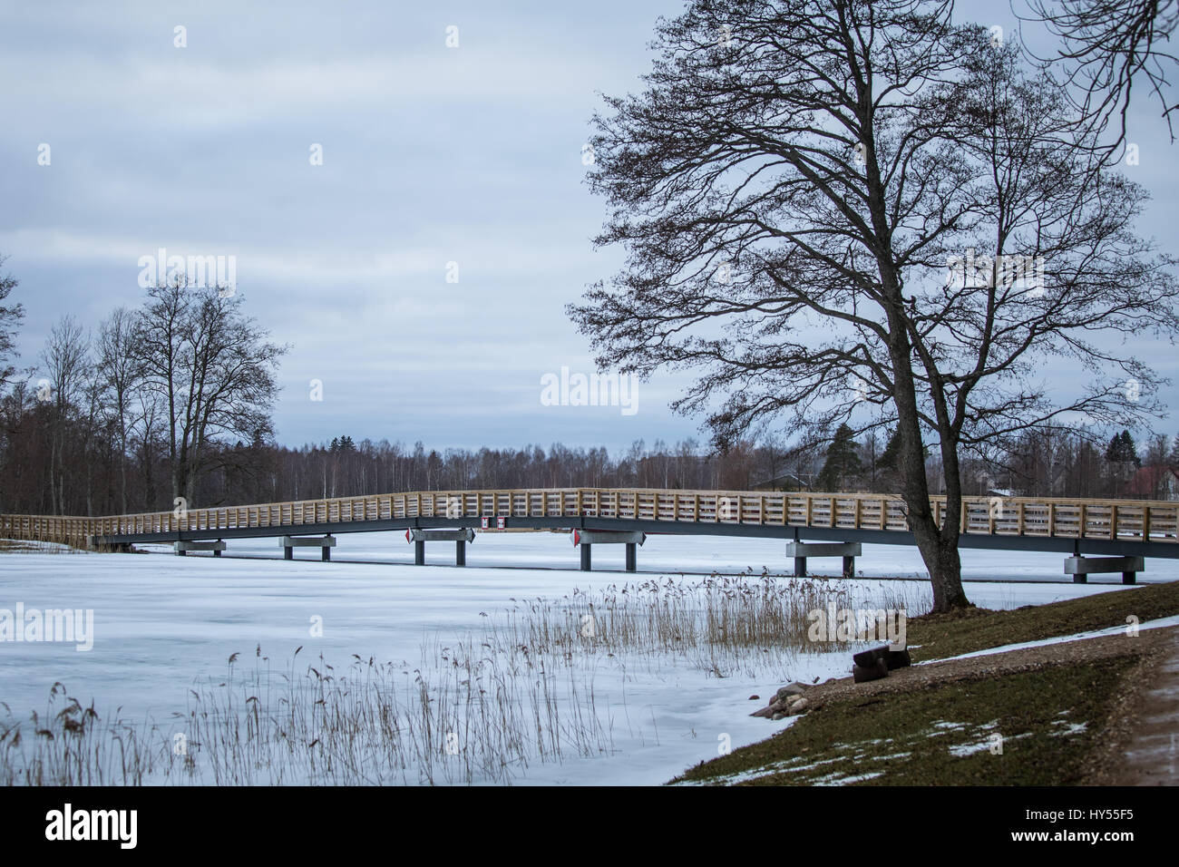 A beautiful winter landscape with a bridge over the frozen river Stock ...