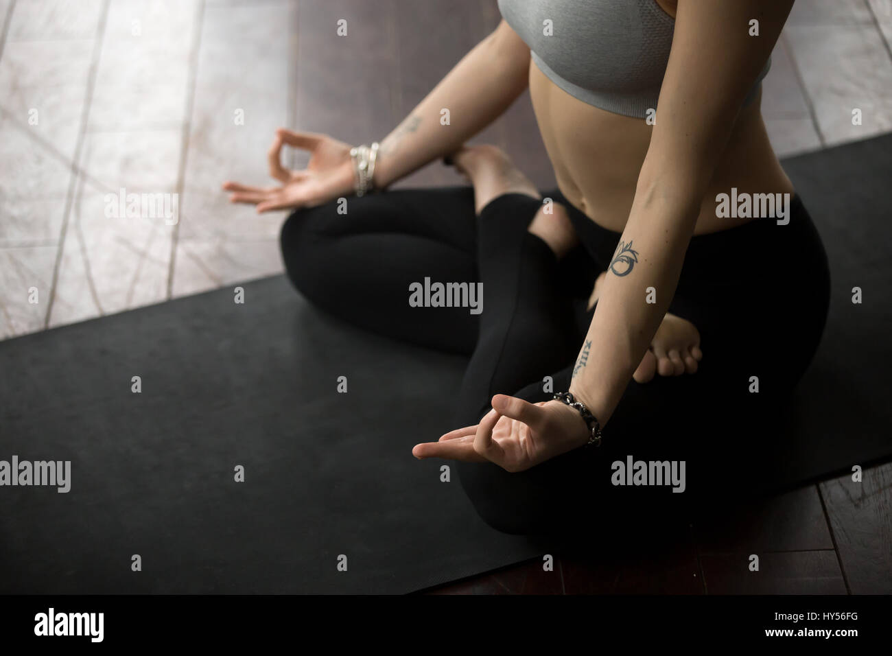 Young woman in Lotus pose doing mudra gesture, studio background Stock ...