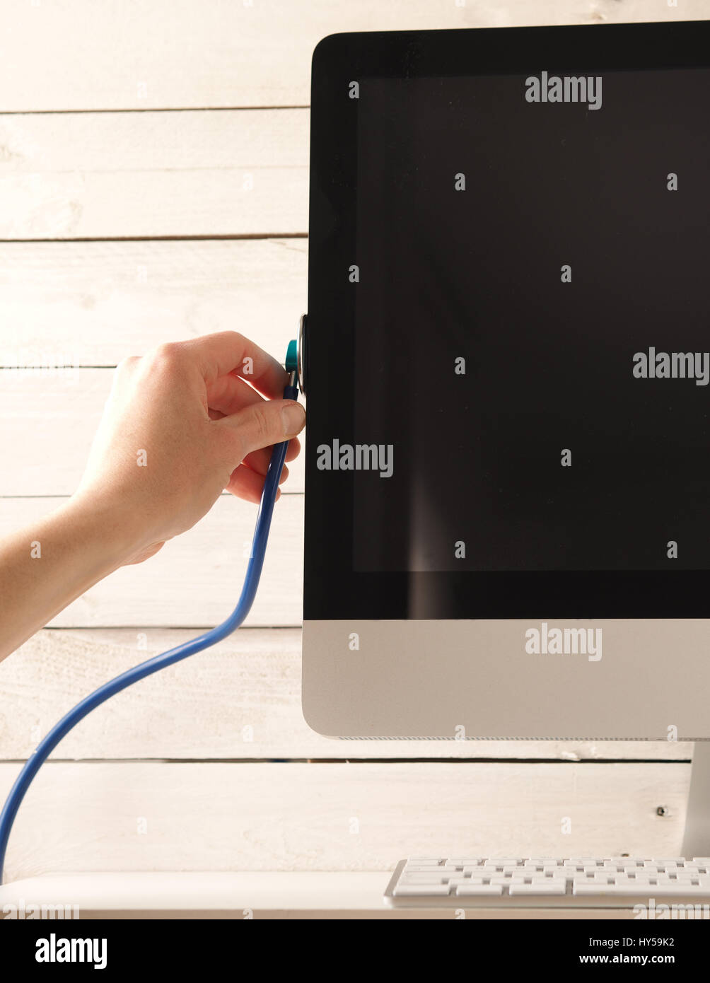 Male hand with stethoscope checking an older computer Stock Photo - Alamy