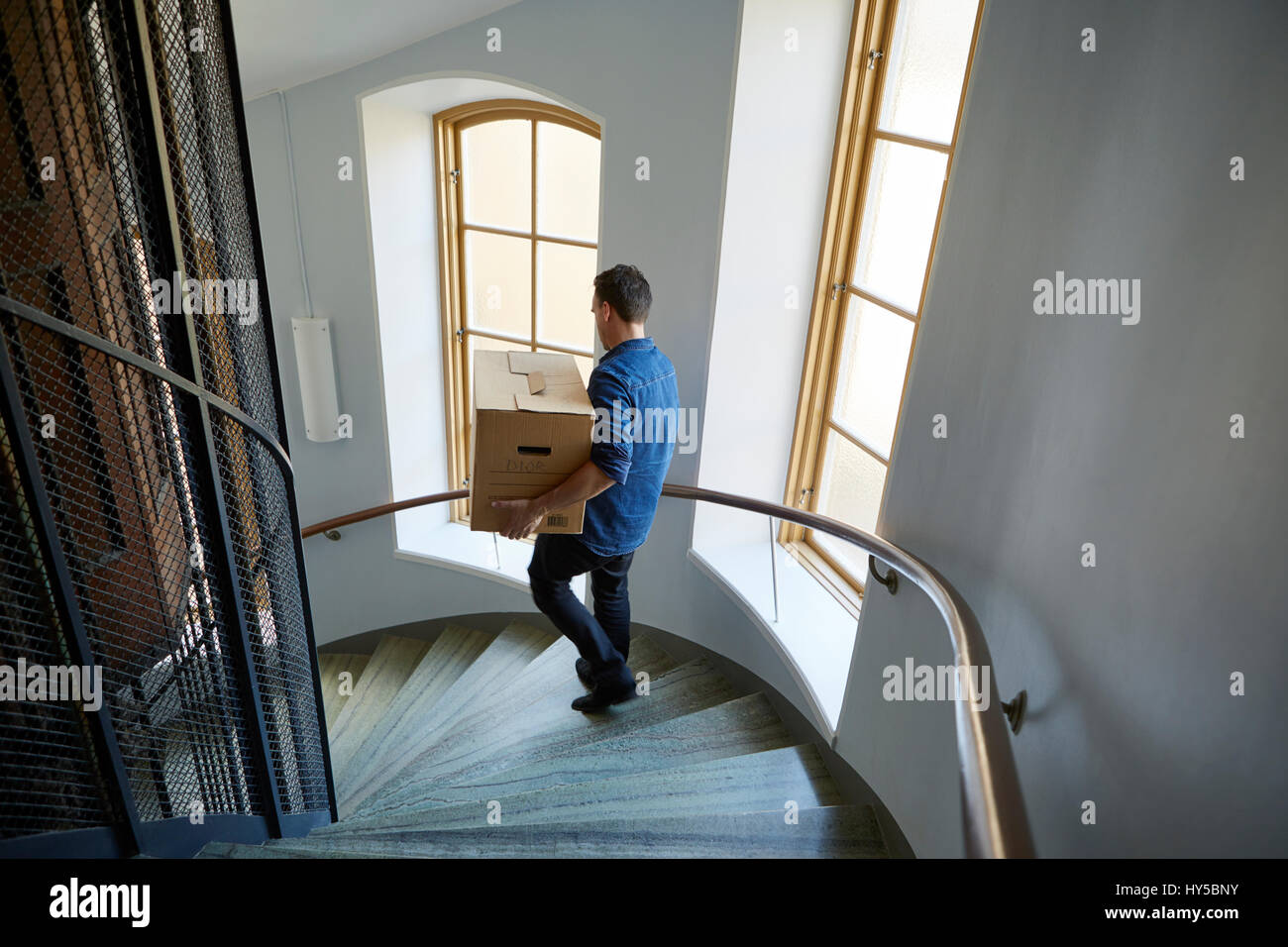 Person carrying box walking hi-res stock photography and images - Alamy
