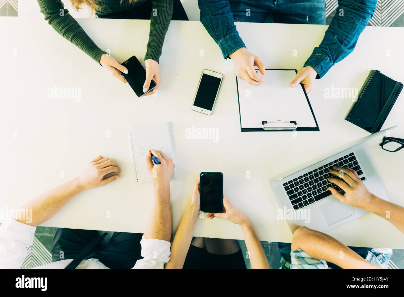 Human hands on the table with mobility devices Stock Photo - Alamy