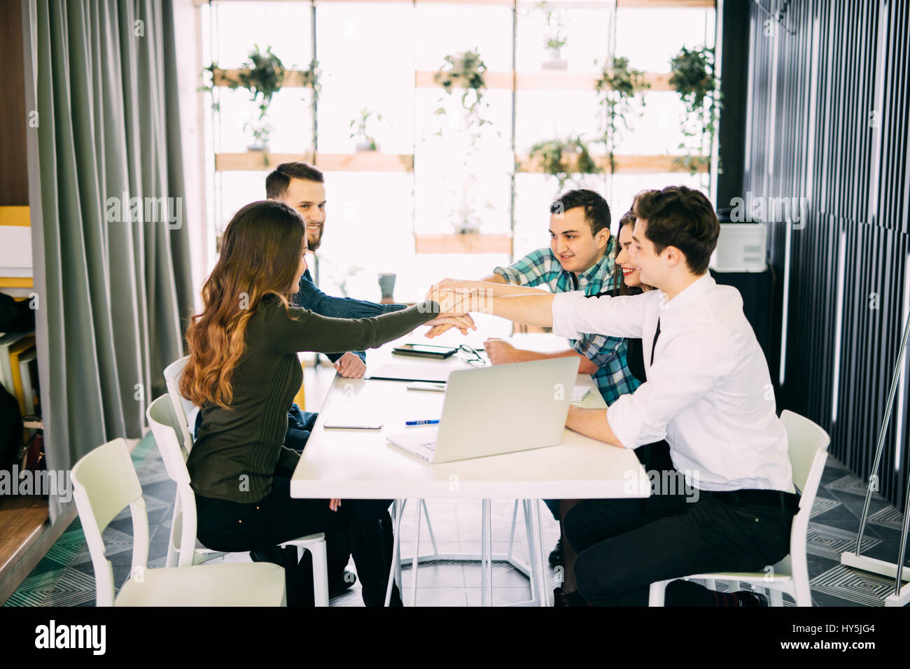 Teambuilding in office, young businessmen and women in casual unite ...