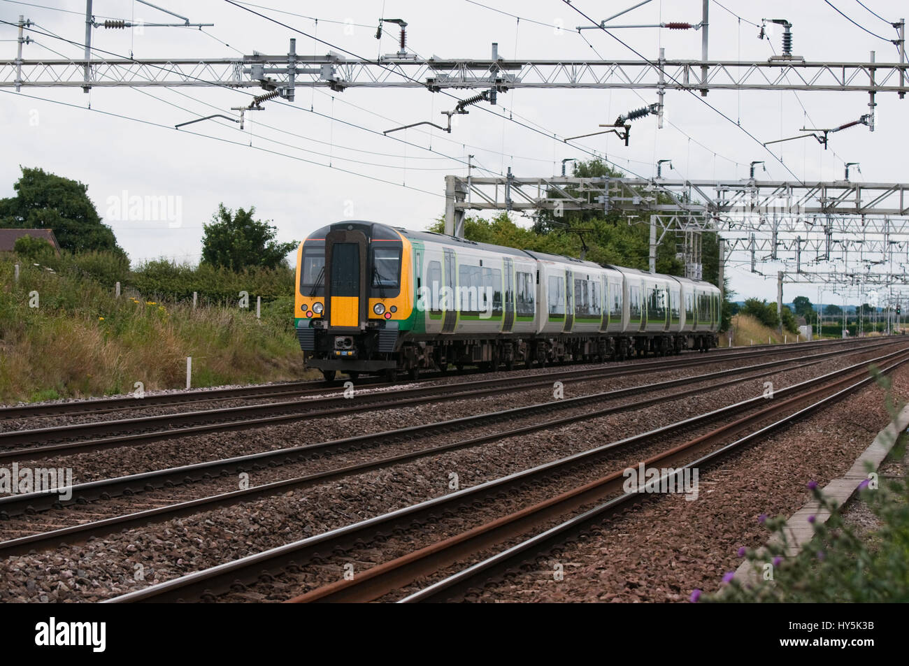 Railway tracks with a passenger train Stock Photo - Alamy