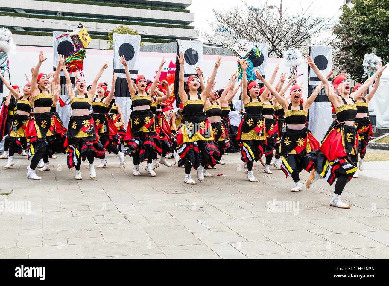 Yosakoi dance festival. Team of young women dancers, dancing with arms ...