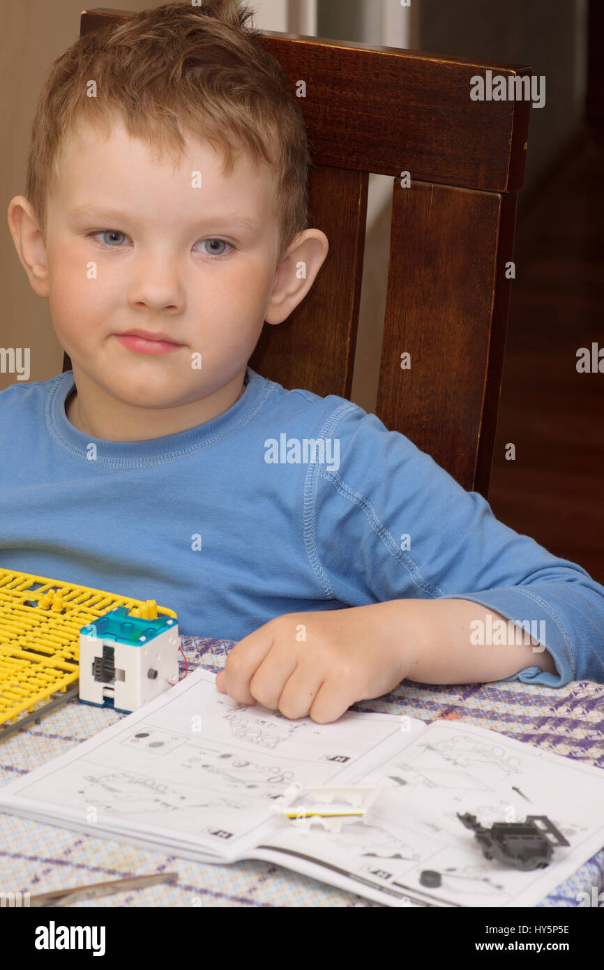 Child blond boy sitting table hi-res stock photography and images - Alamy