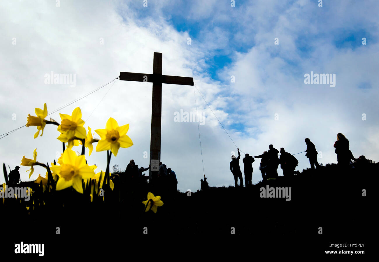 Over 50 people install the 36-feet high cross ahead of Easter on ...