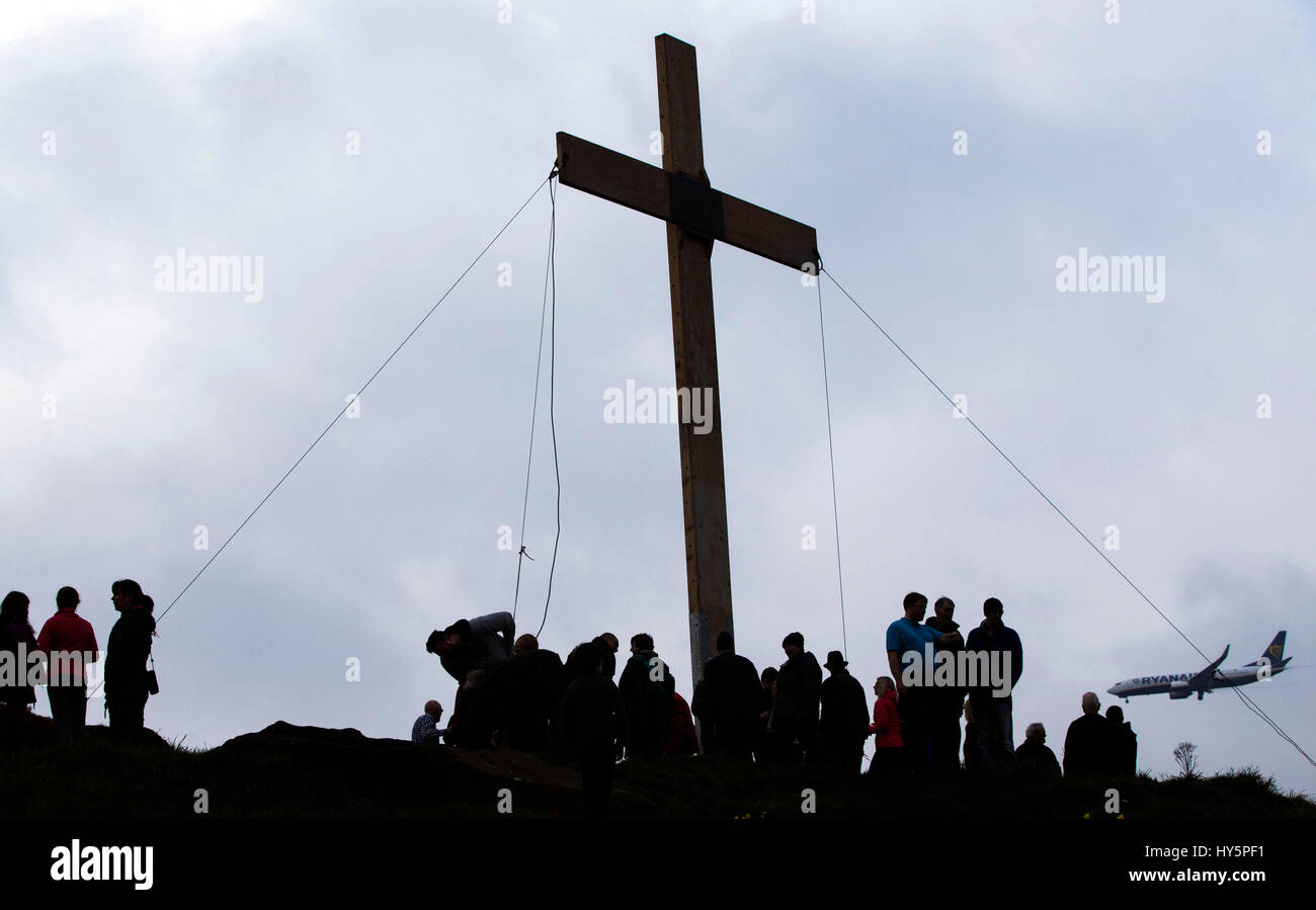 Over 50 people install the 36-feet high cross ahead of Easter on ...