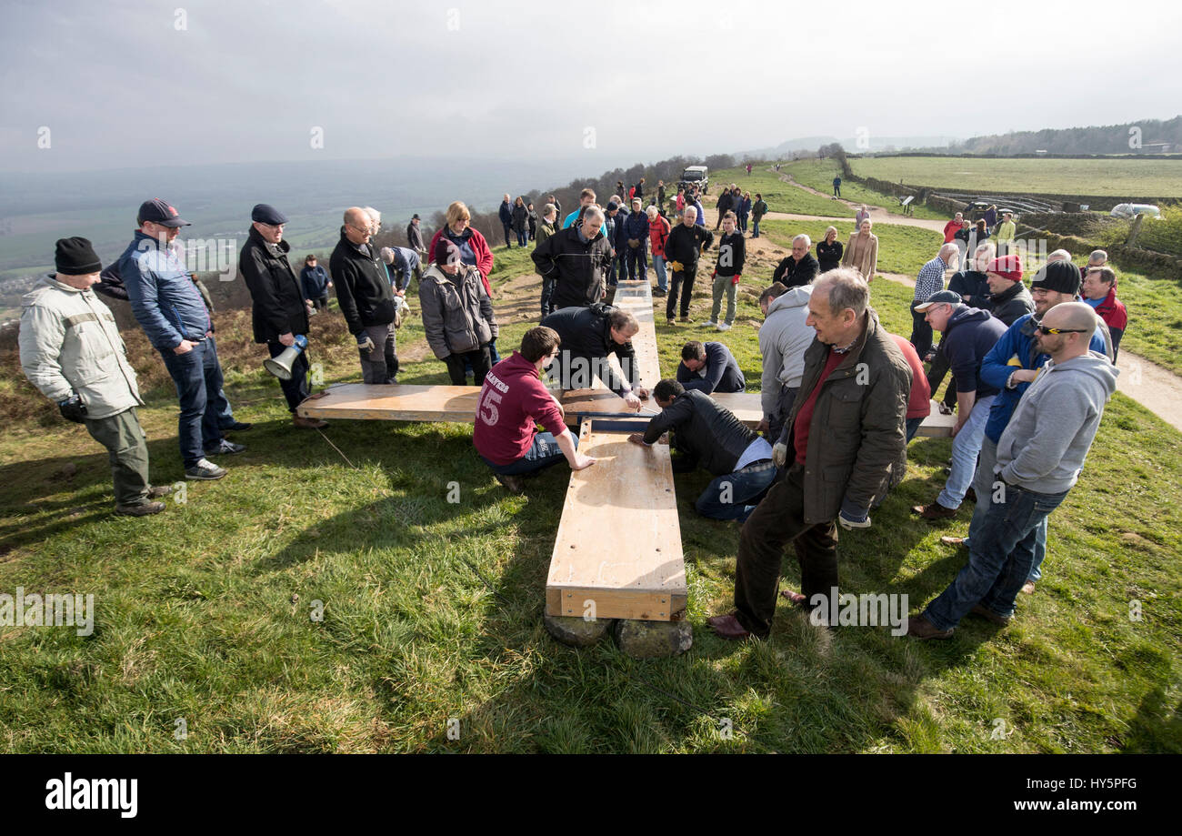 Over 50 people install the 36-feet high cross ahead of Easter on ...