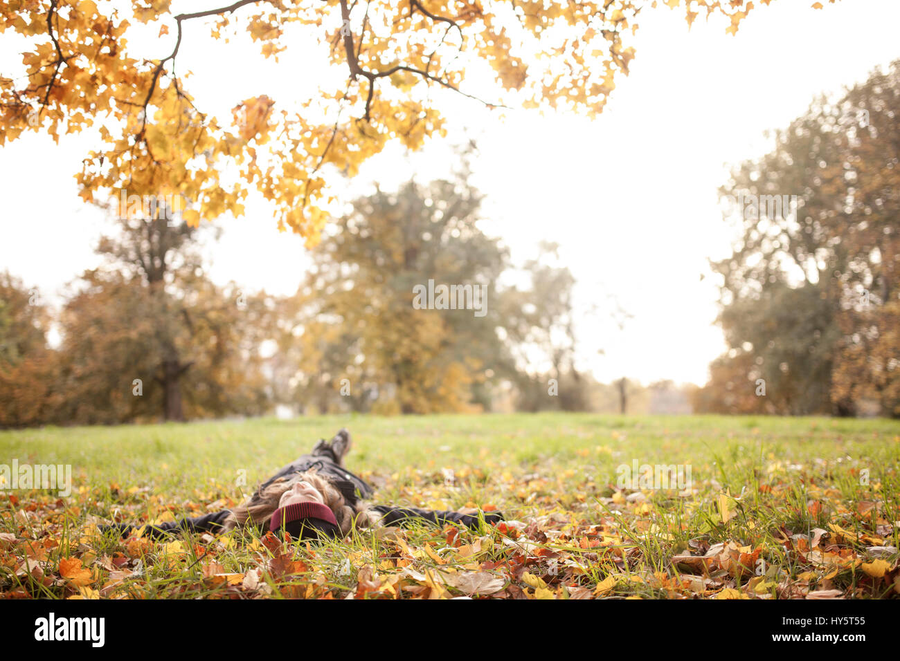 Woman lying under the tree hi-res stock photography and images - Alamy
