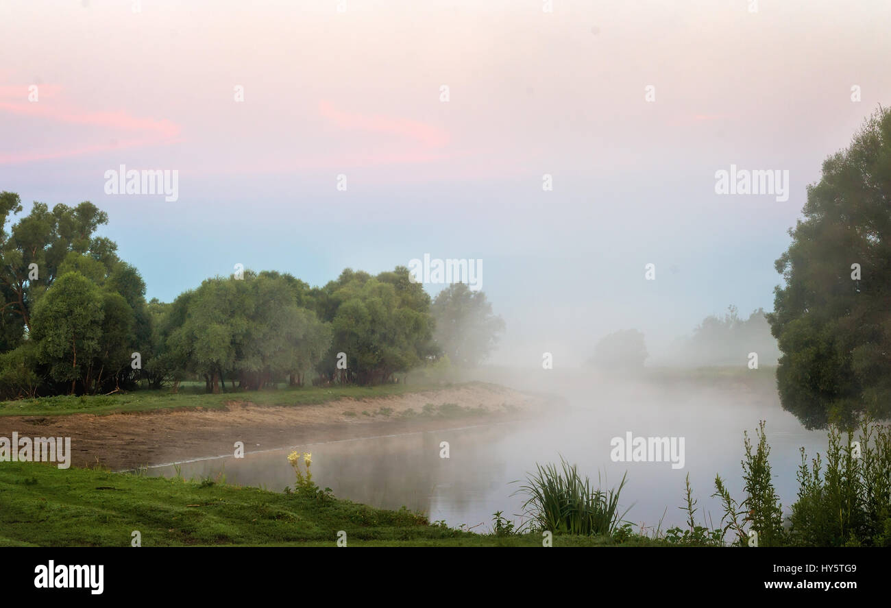 Beautiful calm river with the mist over the surface of the water at ...