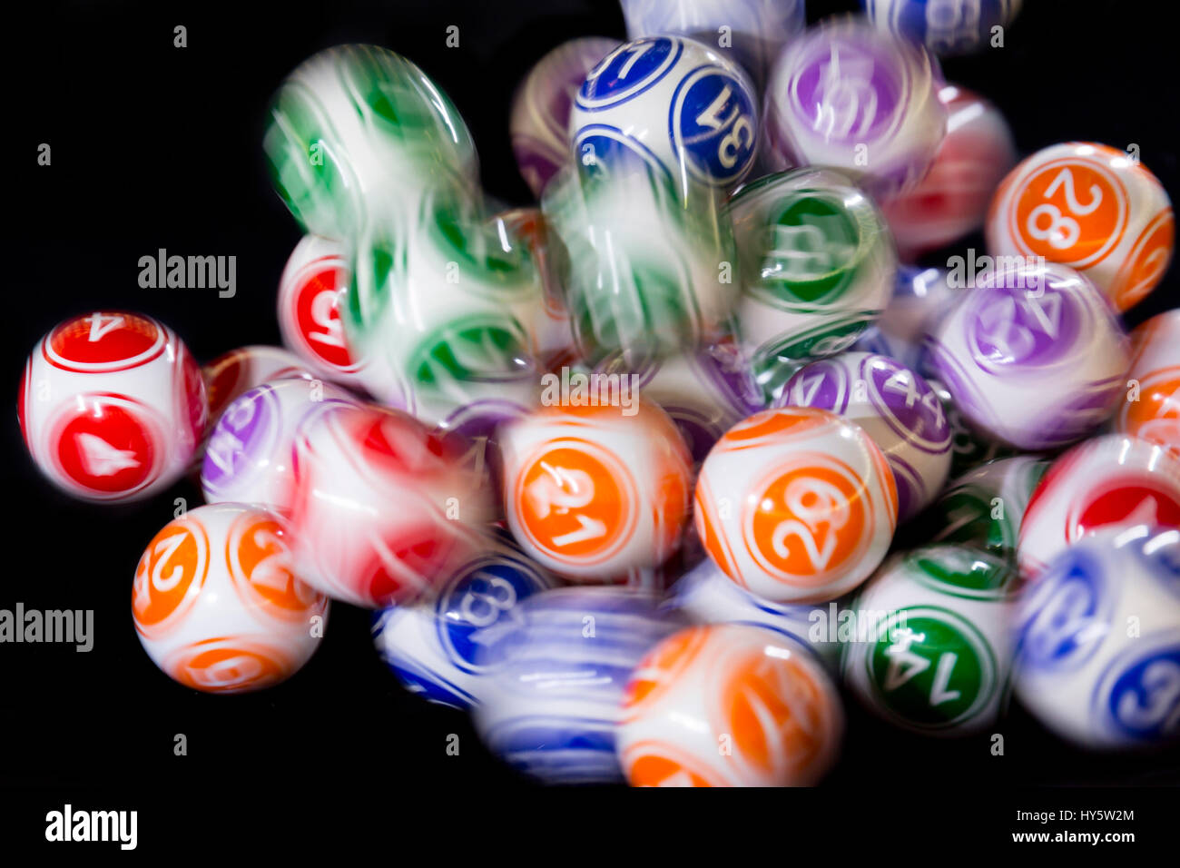 Colourful lottery balls in a bingo machine. Lottery balls in a sphere ...