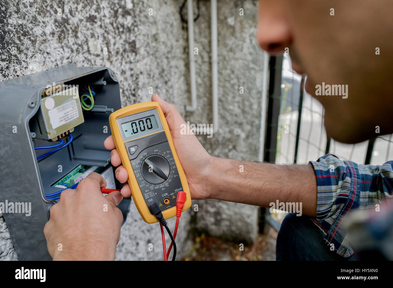Electrician using a voltmeter device Stock Photo - Alamy