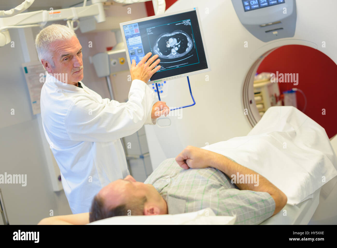 Man having scan, doctor discussing results Stock Photo - Alamy