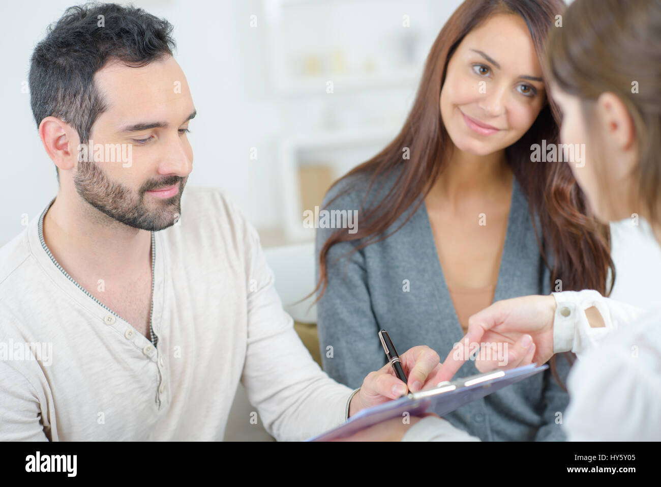 Couple signing form hi-res stock photography and images - Alamy