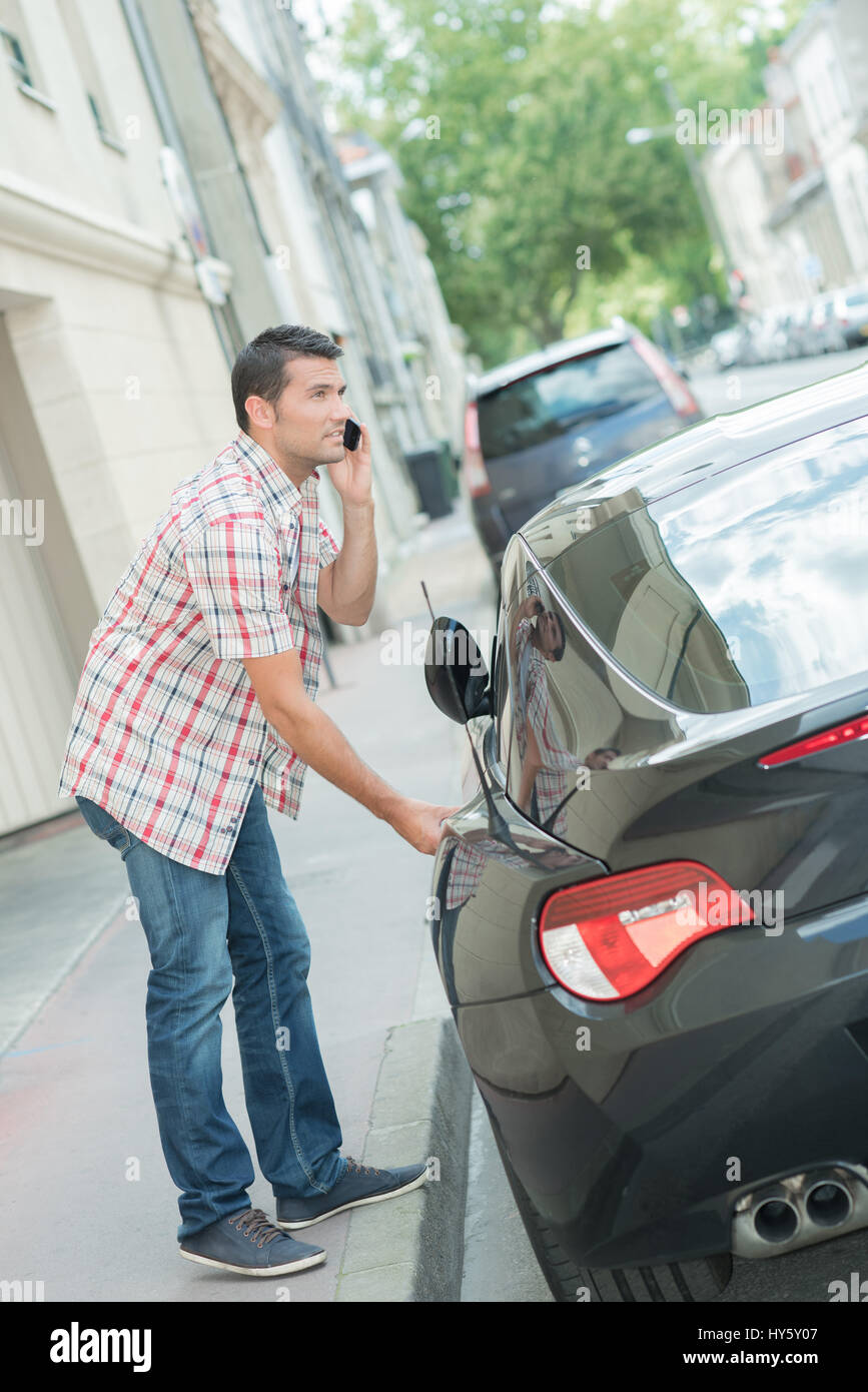 Man opening his car Stock Photo - Alamy