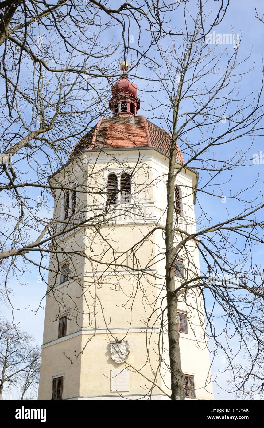 Bell tower Glockenturm behind of trees without leaves at the hill ...