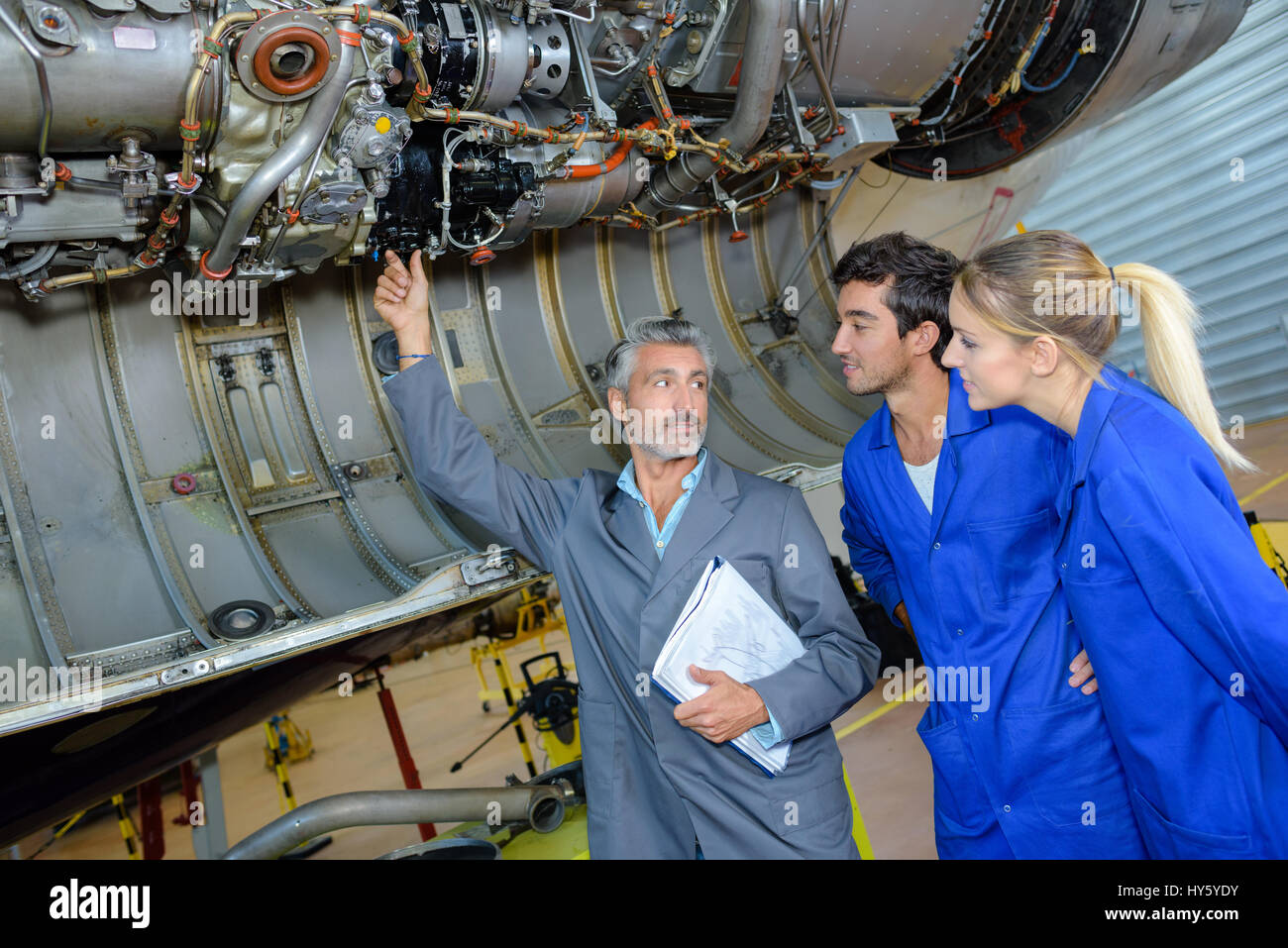engineering teacher checking airplane engines with his students Stock ...