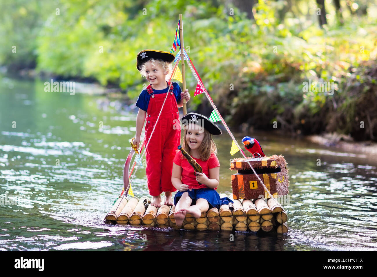 Kids dressed in pirate costumes and hats with treasure chest ...
